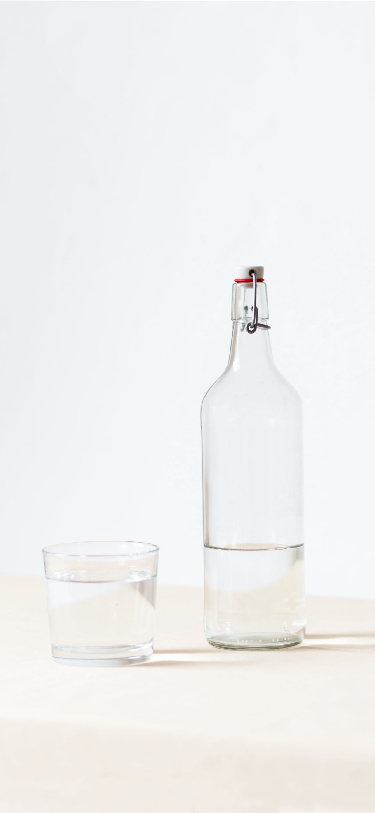 Rocks Glass Beside Half Empty Bottle On White Surf IPhone Wallpapers